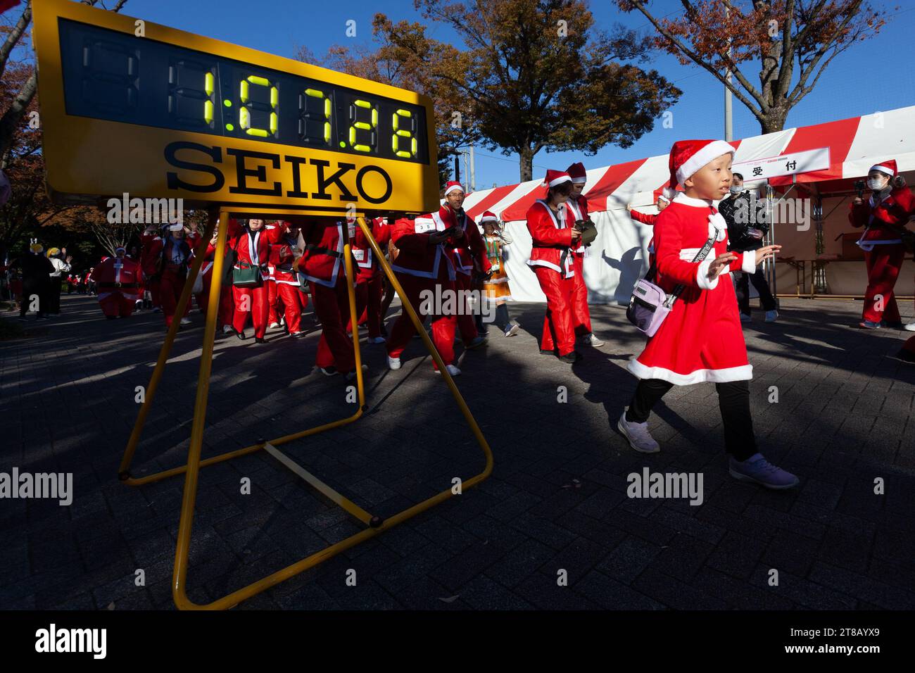 Tokyo, Japan. 19th Nov, 2023. People wearing Santa Claus costumes cross ...