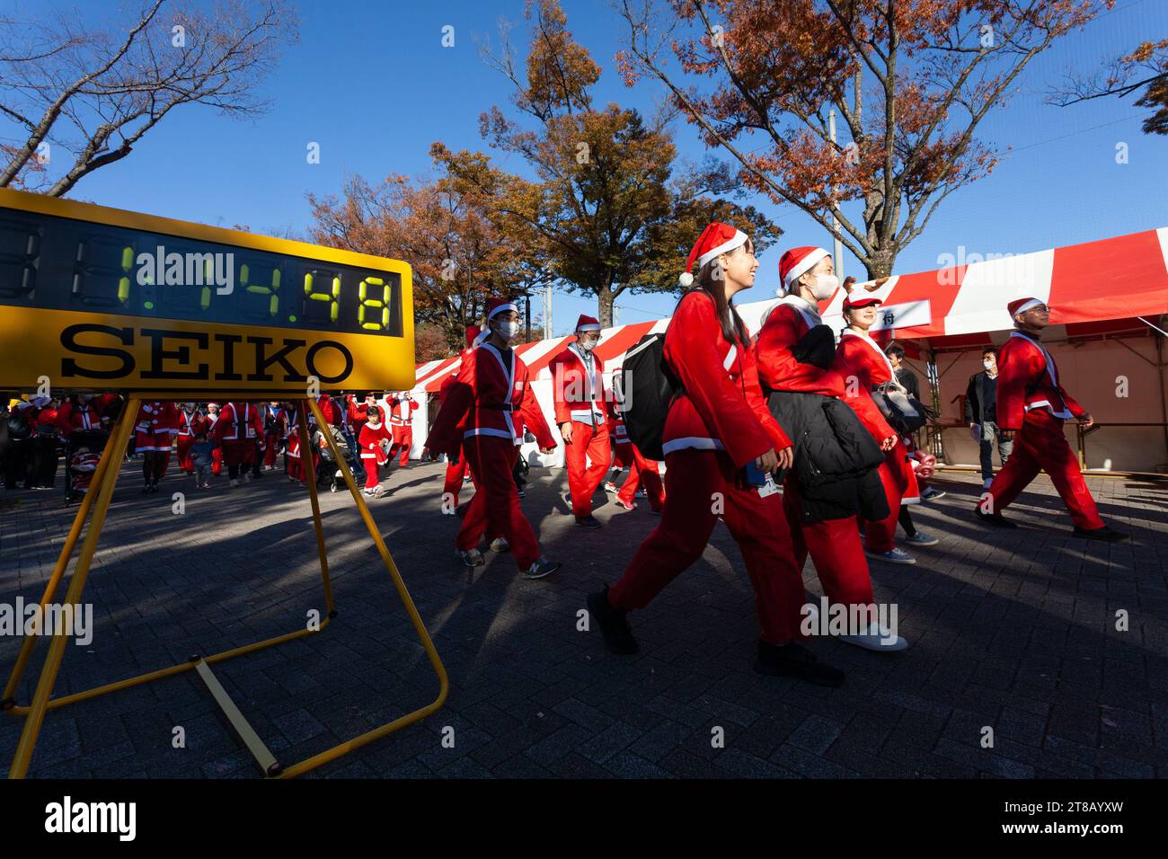 Tokyo, Japan. 19th Nov, 2023. People wearing Santa Claus costumes cross ...