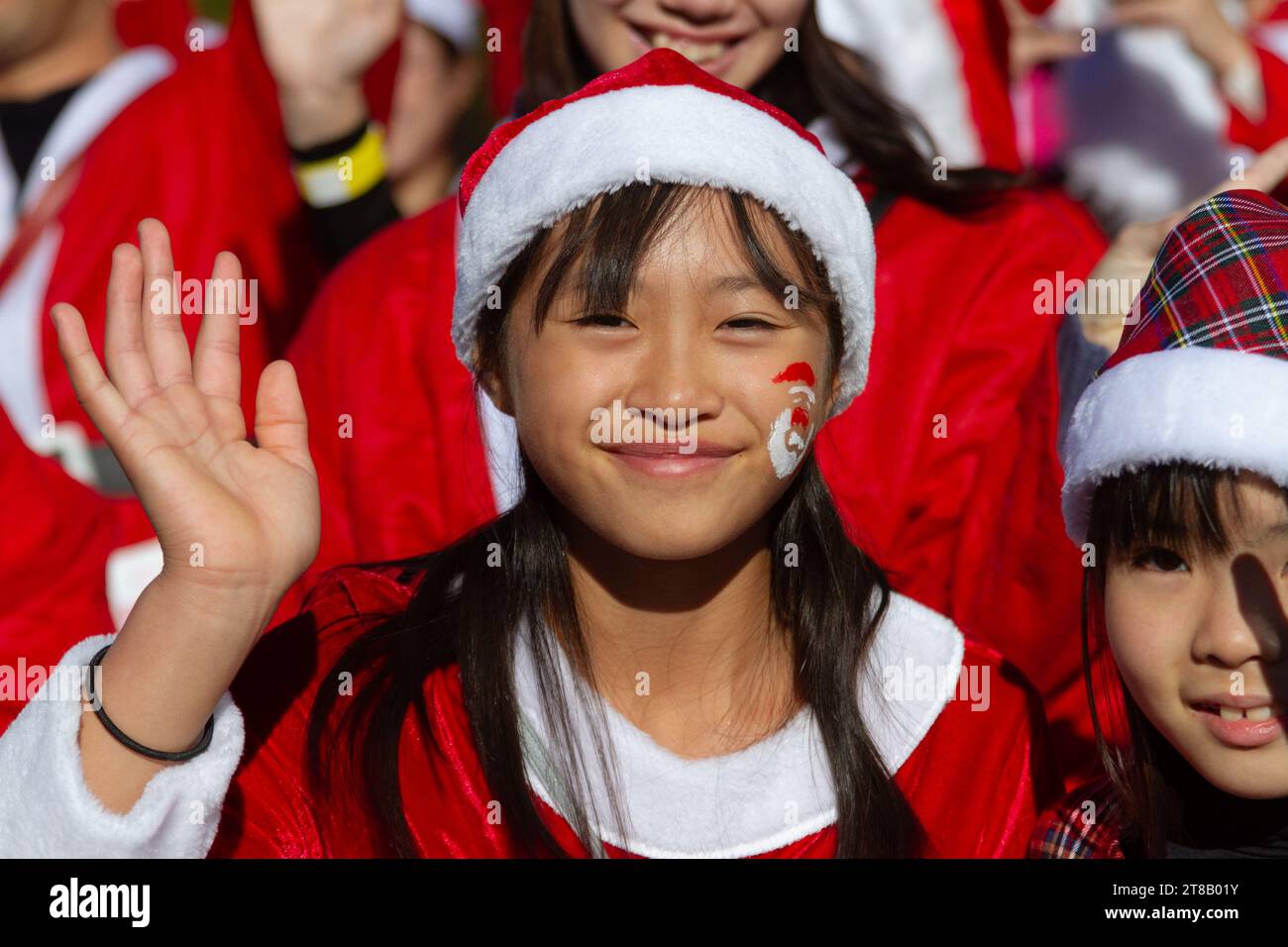 Tokyo, Japan. 19th Nov, 2023. A young Japanese girl waves among ...