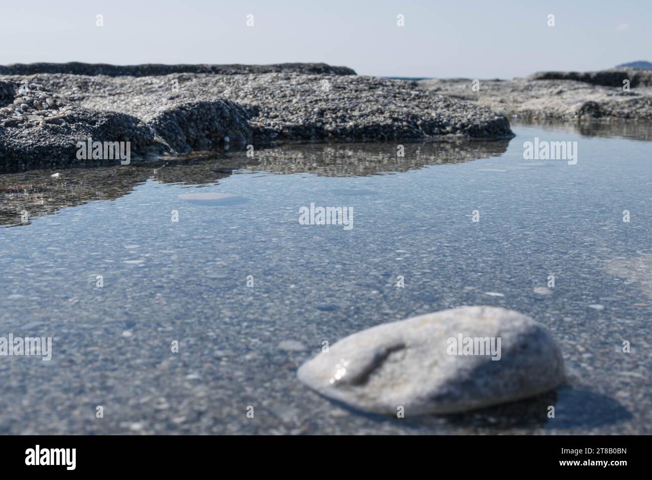 puddles of water with water on a wet asphalt road after heavy rain ...