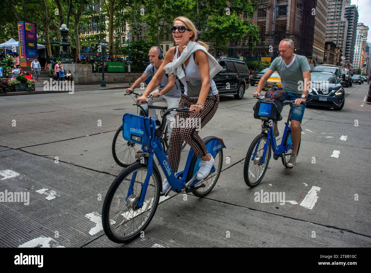 tourists with rented bicycles city bikes in Bryant park Manhattan, New ...