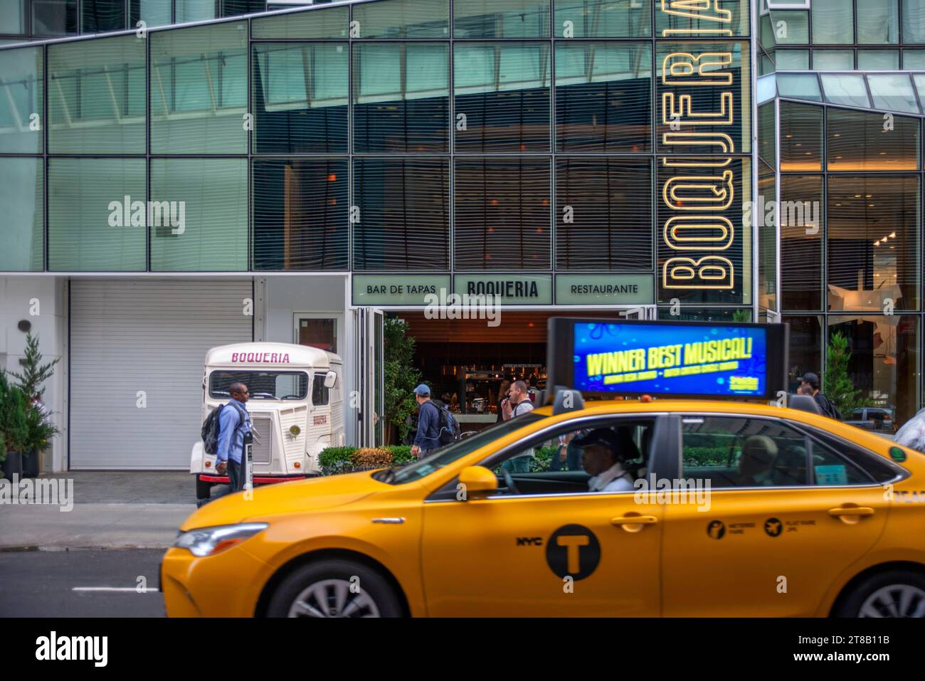 Taxi cab in front of the Boqueria tapas bar with people around in ...