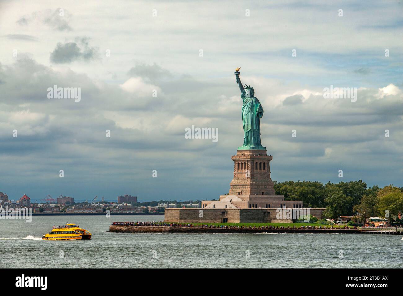 Statue of Liberty in New York and the water ferry taxi Stock Photo - Alamy