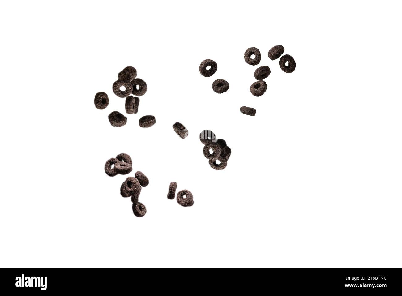 Chocolate rings cereal spill out into a bowl. Breakfast. Isolated on a ...