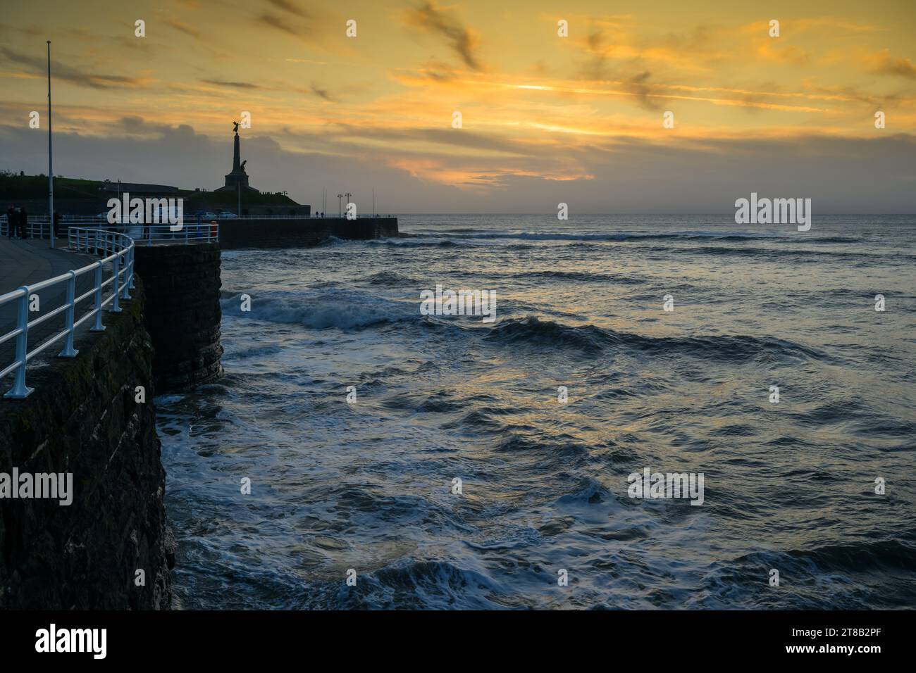 Angry seas hitting the sea wall during a storm at dusk, Aberystwyth ...