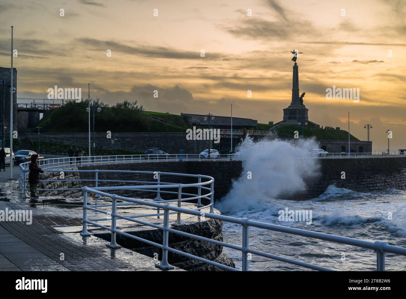 Angry seas hitting the sea wall during a storm at dusk, Aberystwyth ...