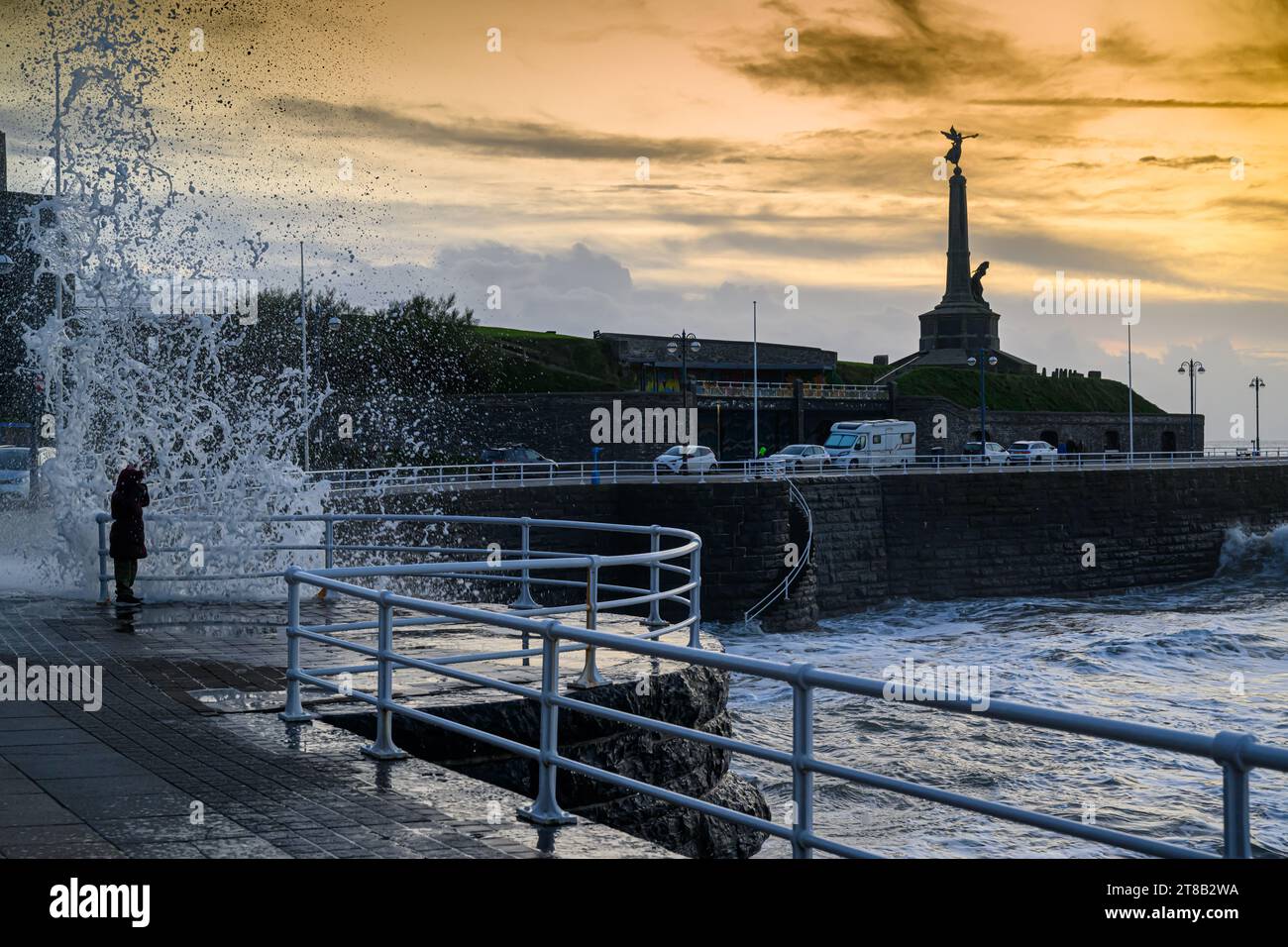 Angry seas hitting the sea wall during a storm at dusk, Aberystwyth ...