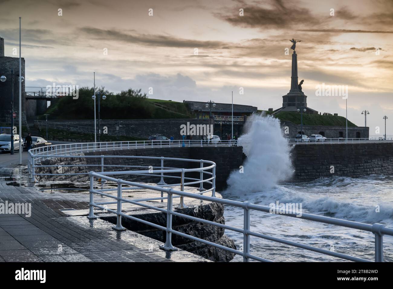 Angry seas hitting the sea wall during a storm at dusk, Aberystwyth ...
