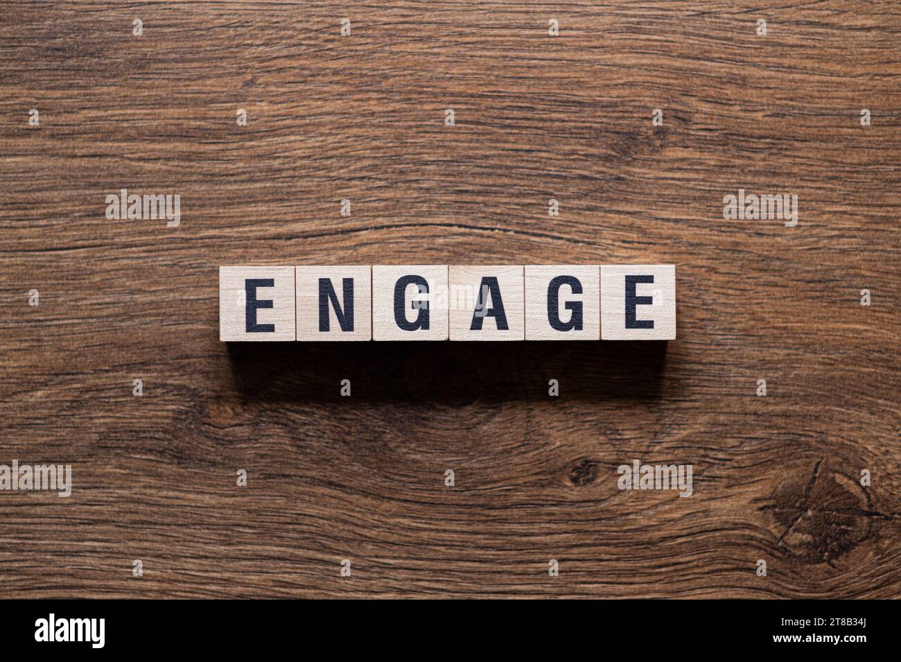 Engage - word concept on building blocks, text Stock Photo - Alamy