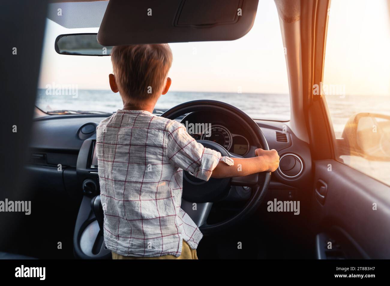 Cute little boy playing in car and acting like real adult driver Stock ...