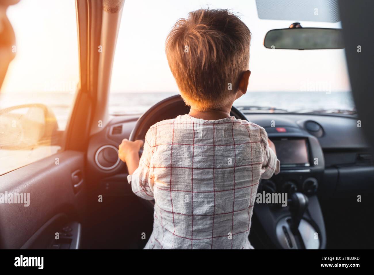Cute little boy playing in car and acting like real adult driver Stock ...