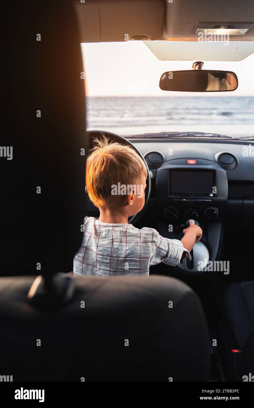 Cute little boy playing in car and acting like real adult driver Stock ...