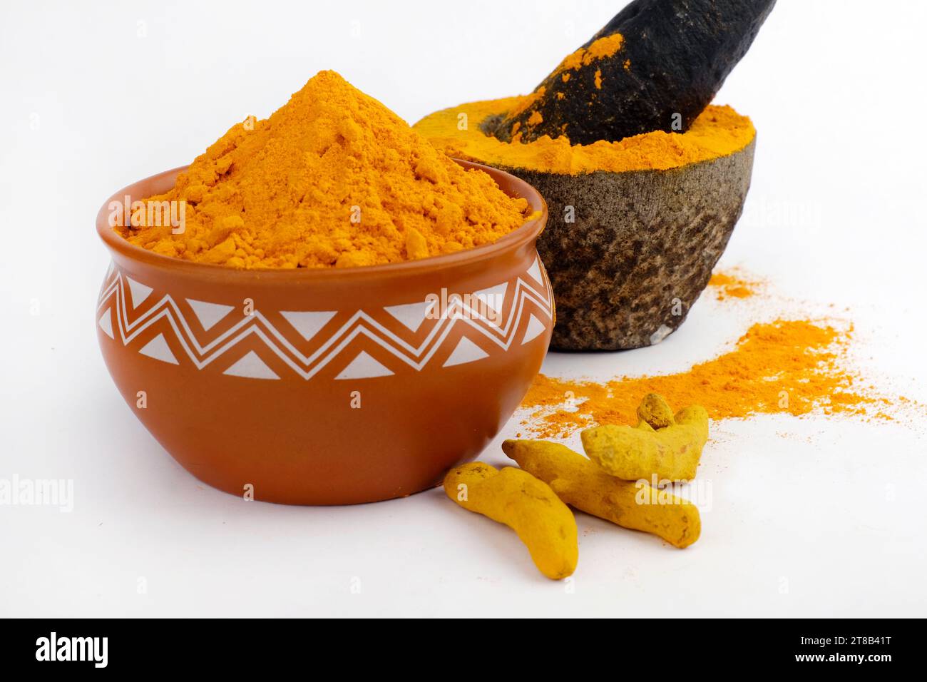 Dry turmeric powder (curcuma longa linn) stone mortar, traditional ...