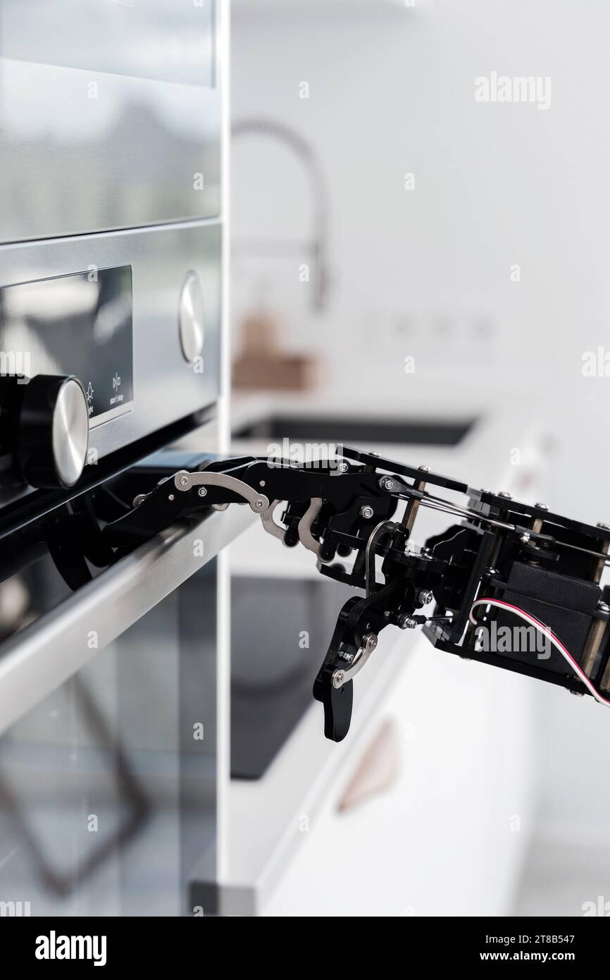 Real robot's hand and electric oven. Concept of robotic process ...