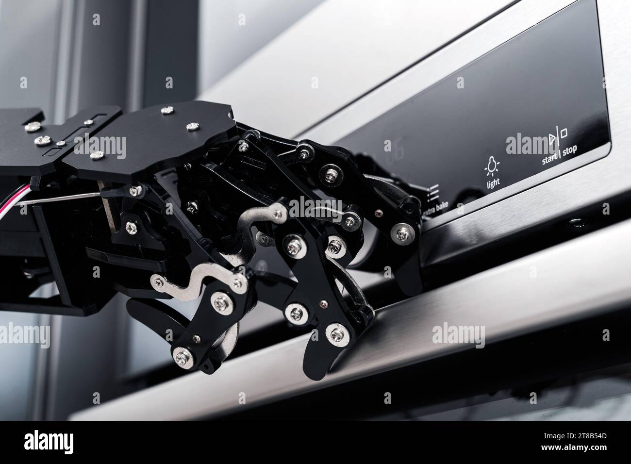 Real robot's hand and electric oven. Concept of robotic process ...