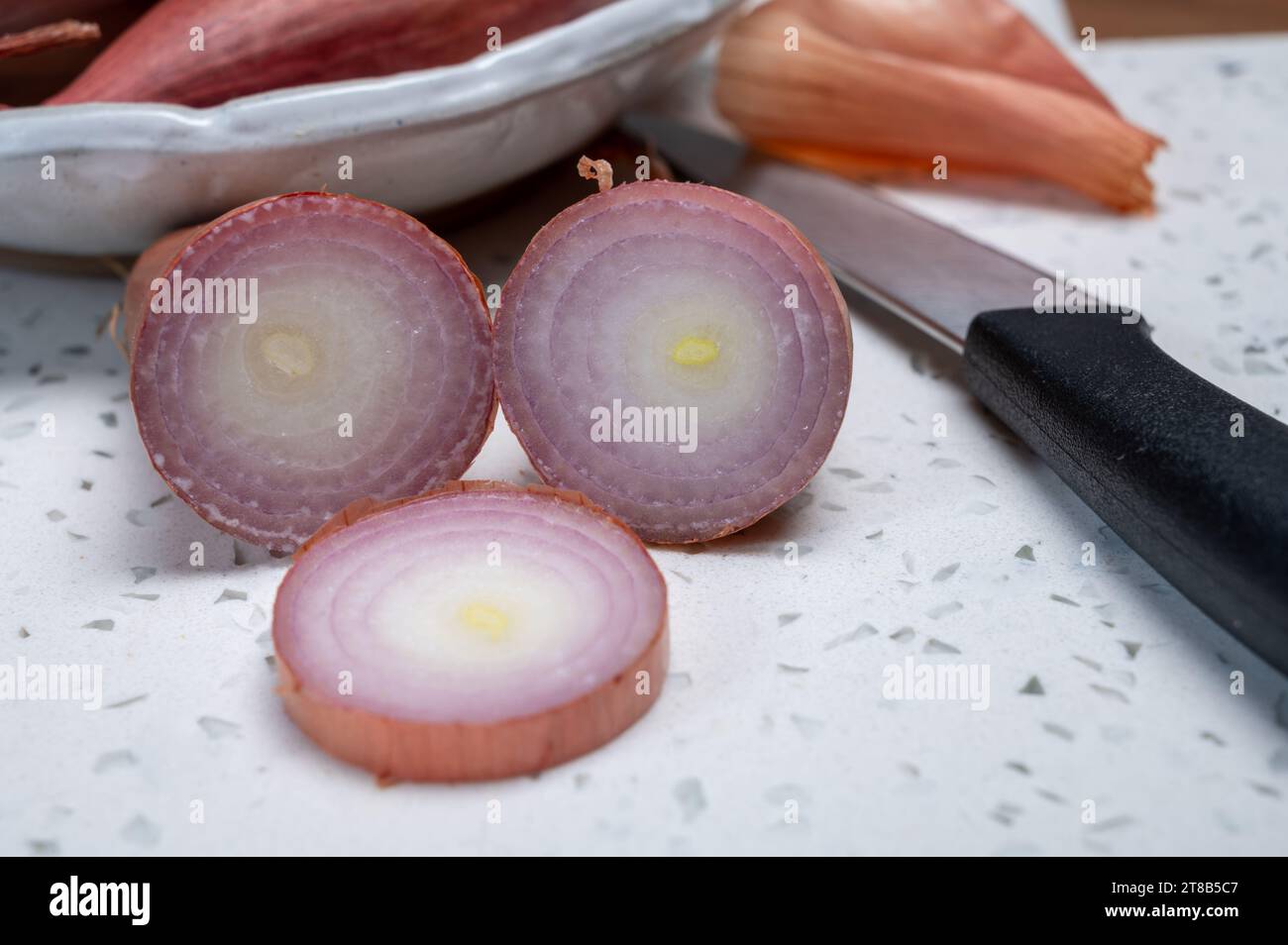 French long pink shallots grappe onion from Brittany, France close up ...