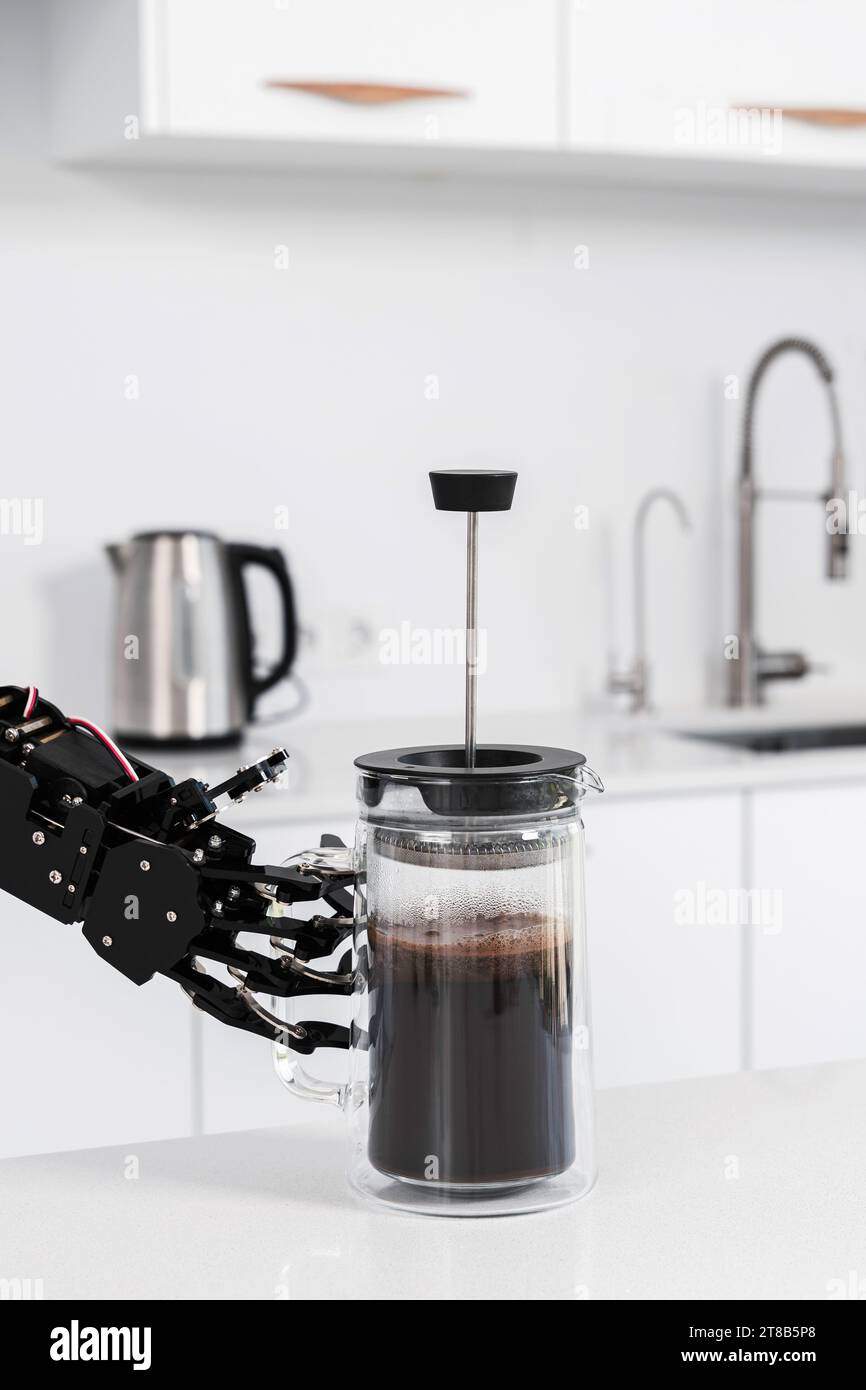 Real robot's hand and French press with black coffee. Concept of ...