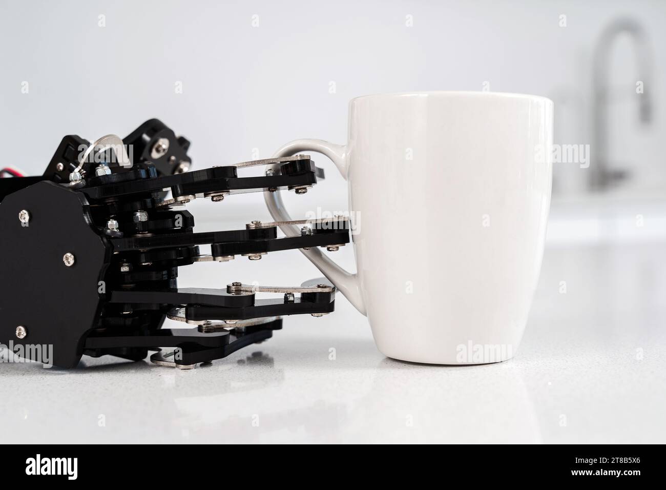 Real robot hand and white cup of coffee. Concept of robotic process ...
