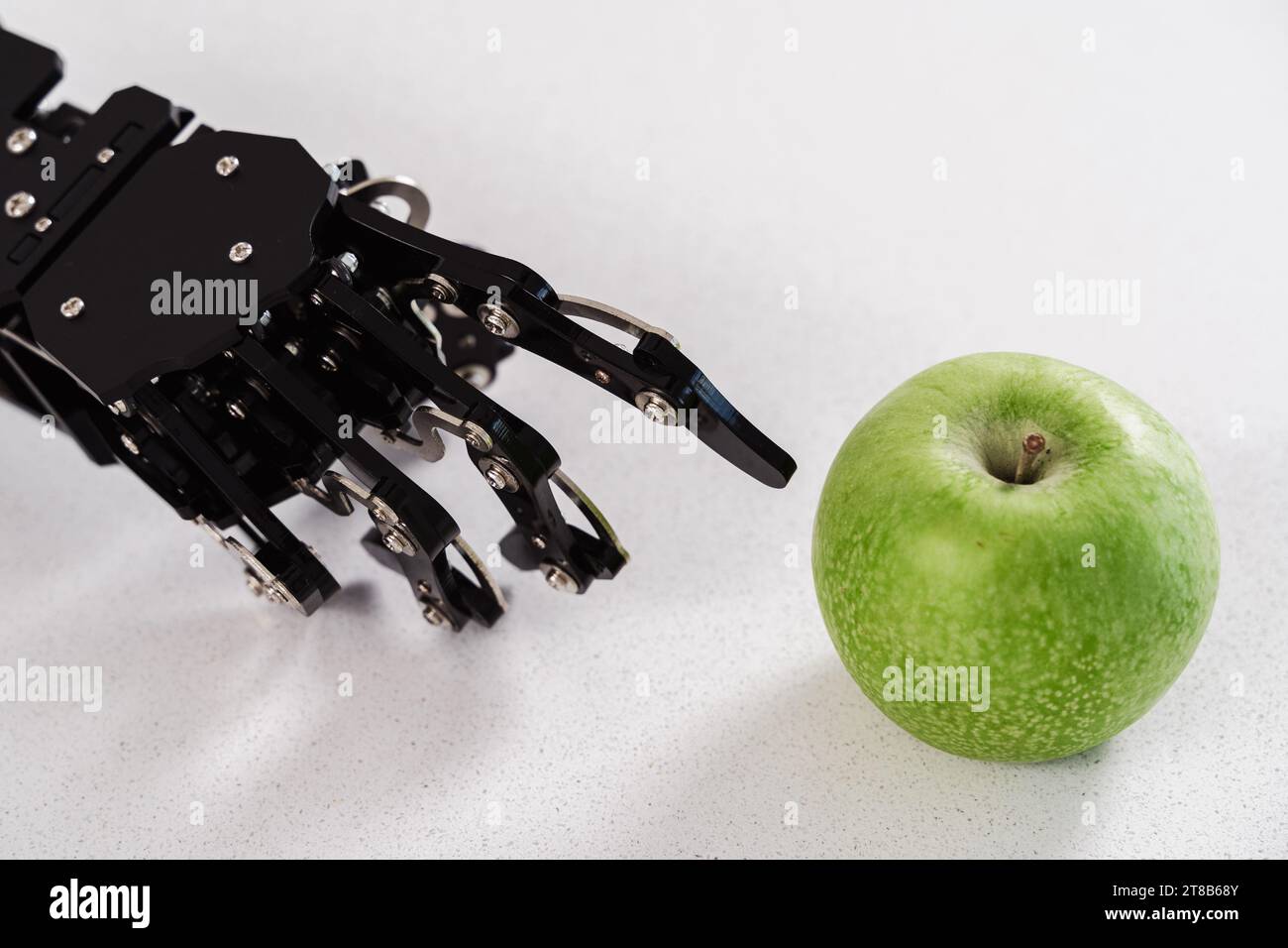 Real robot's hand with green apple. Concept of Artificial intelligence ...