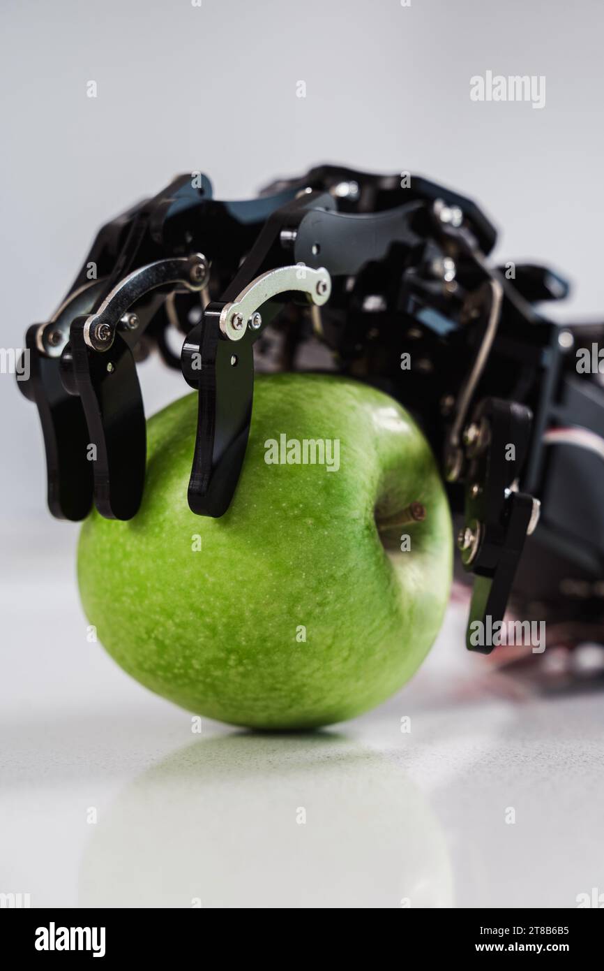 Real robot's hand with green apple. Concept of Artificial intelligence ...