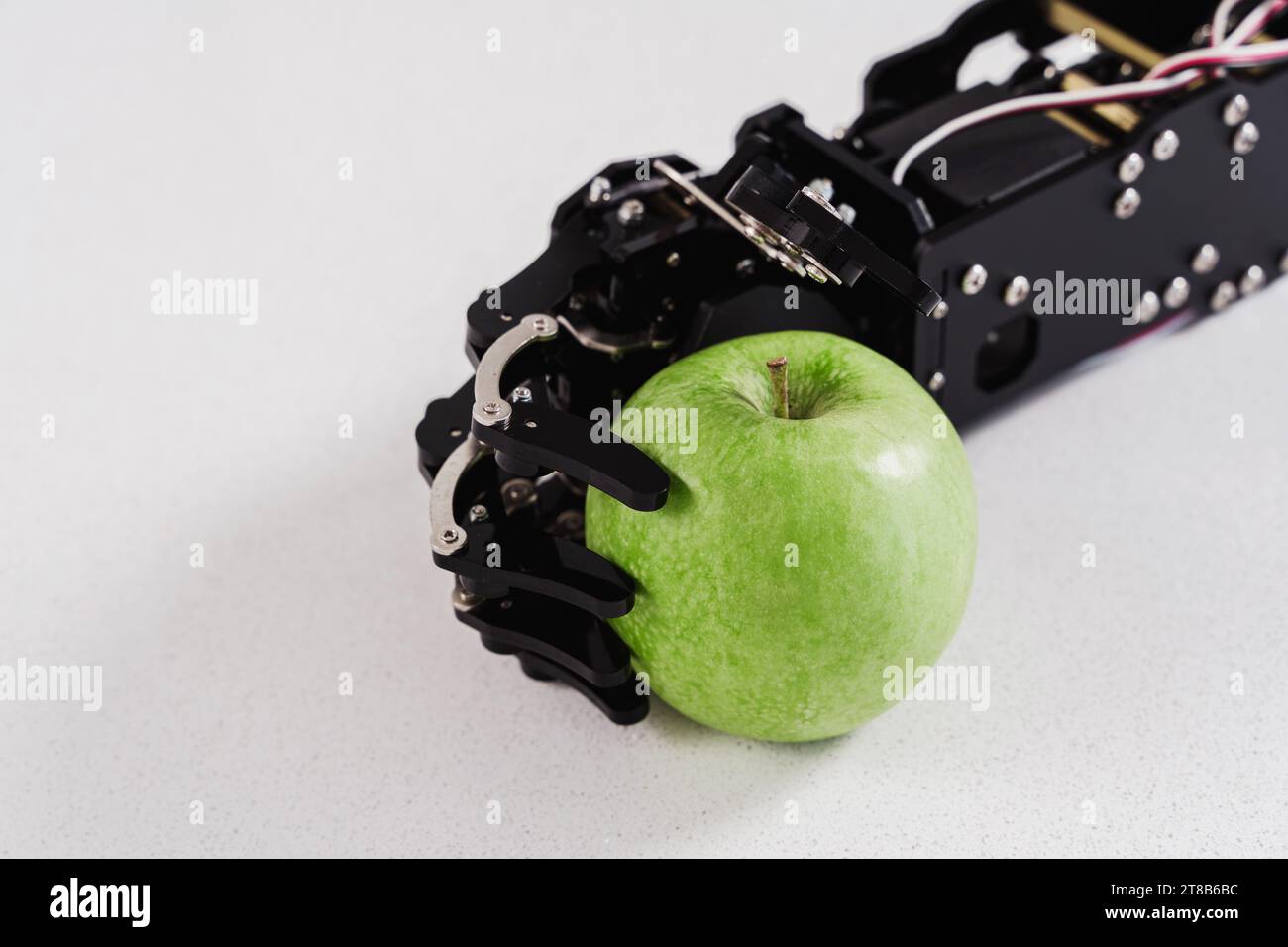 Real robot's hand with green apple. Concept of Artificial intelligence ...