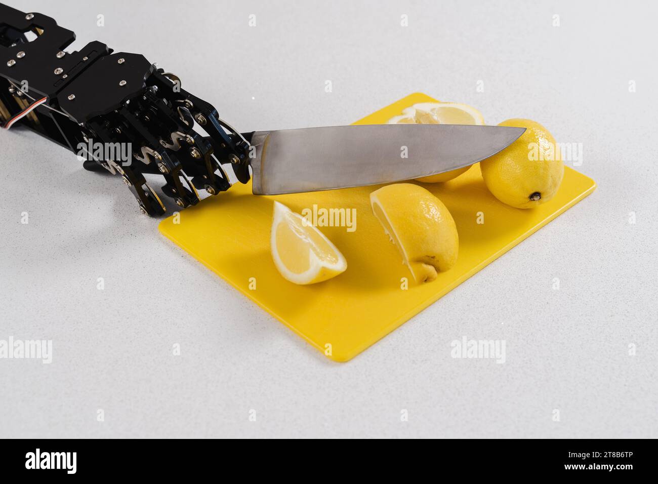 Real robot's hand cutting lemons with sharp knife. Concept of robotic ...
