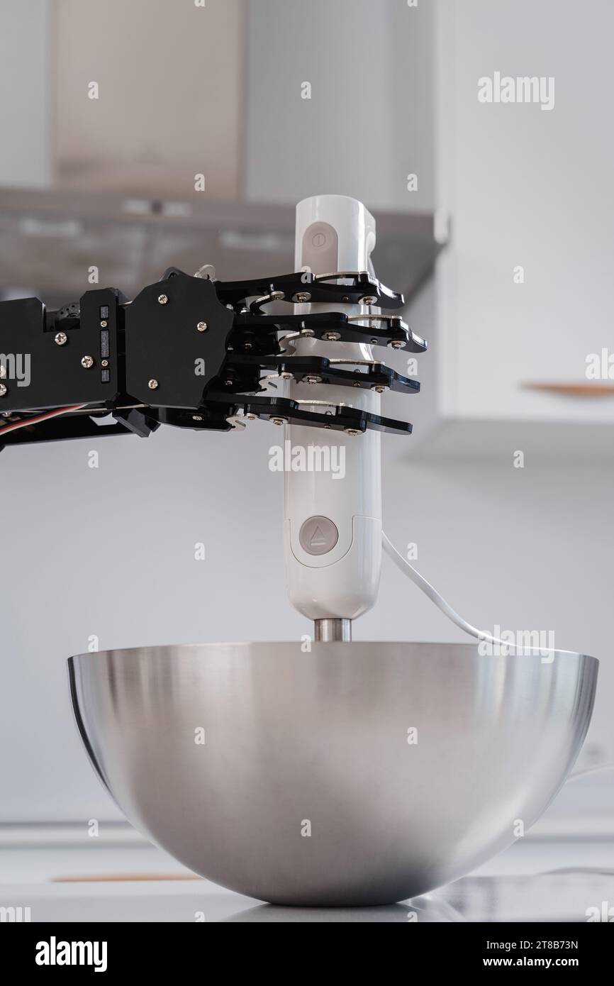 Real robot hand and immersion blender. Concept of robotic process ...