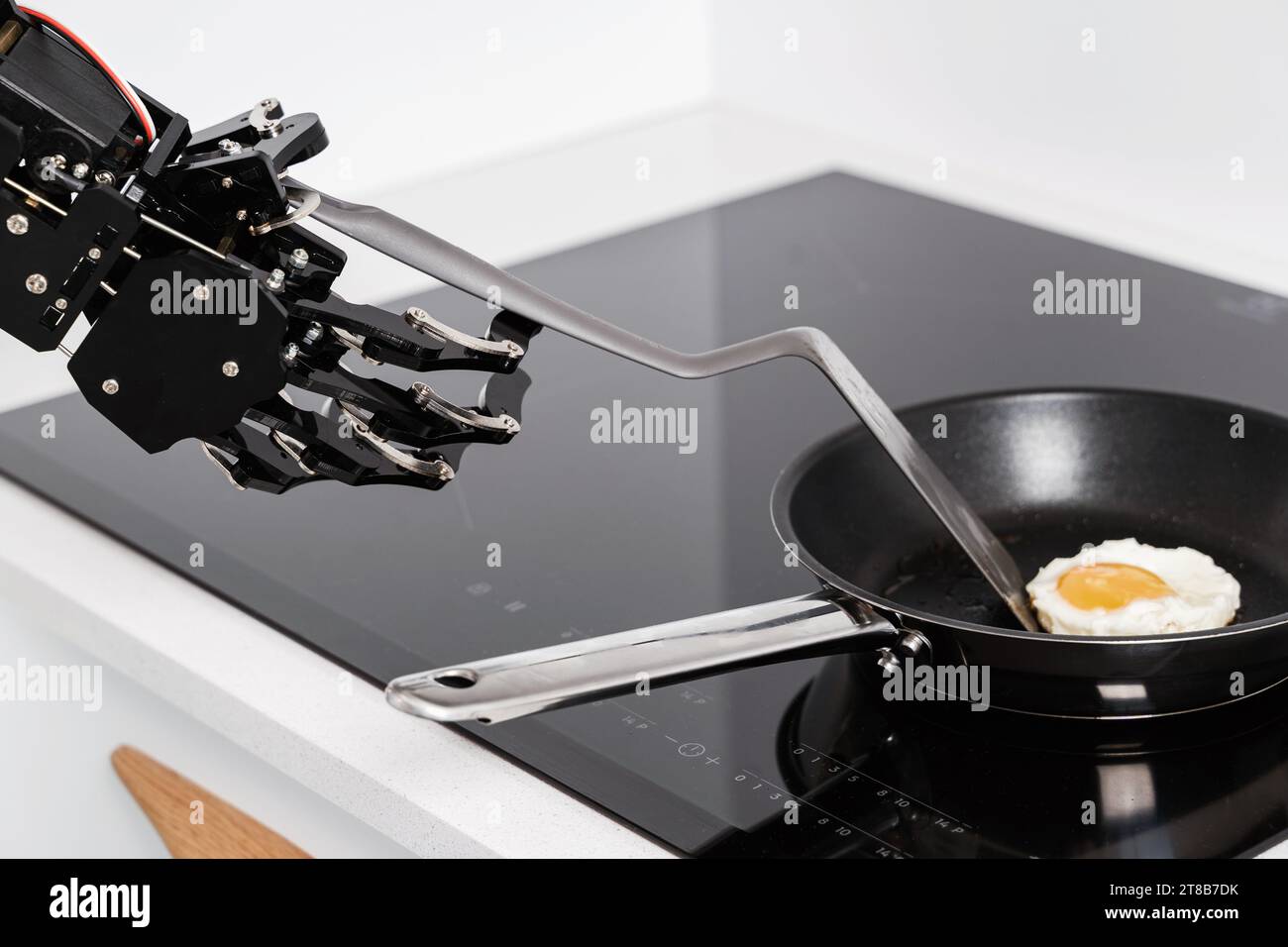 Real robot hand and frying pan with fried egg. Concepts of AI ...