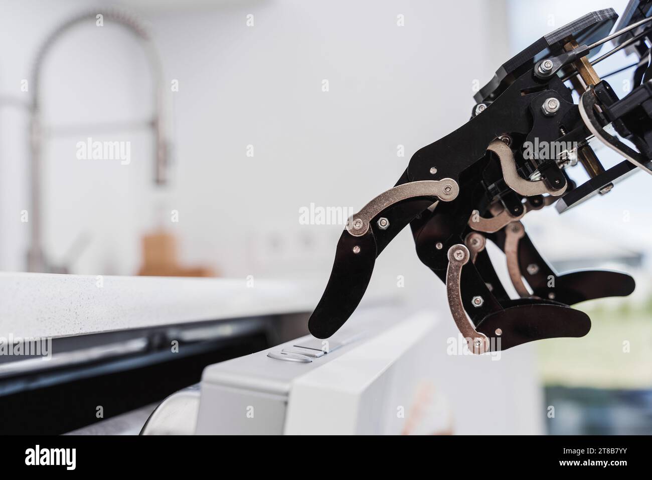 Real robot hand pushing button on dishwasher. Concept of Artificial ...