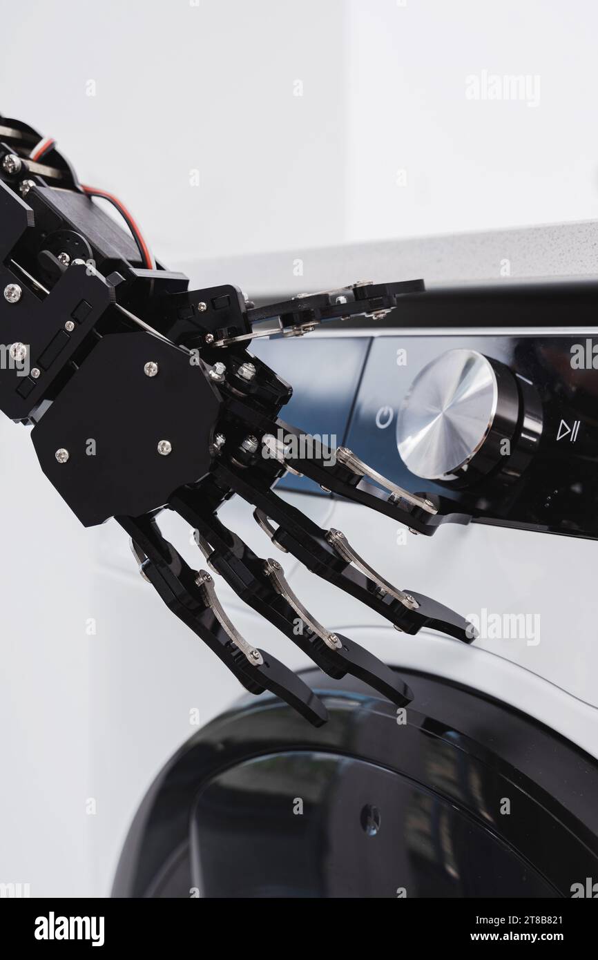 Real robot's hand and washing machine. Concept of Artificial ...