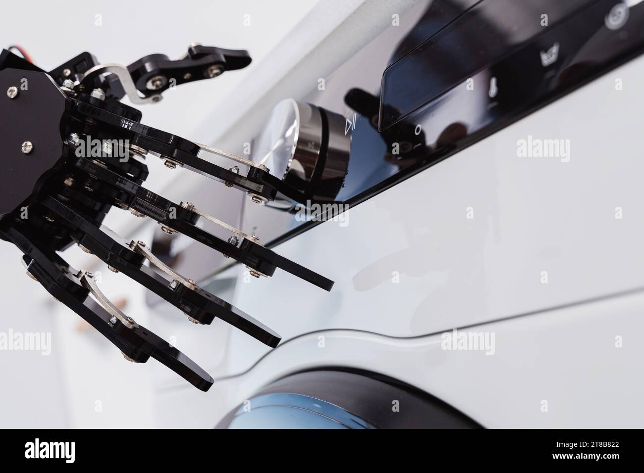 Real robot's hand and washing machine. Concept of Artificial ...