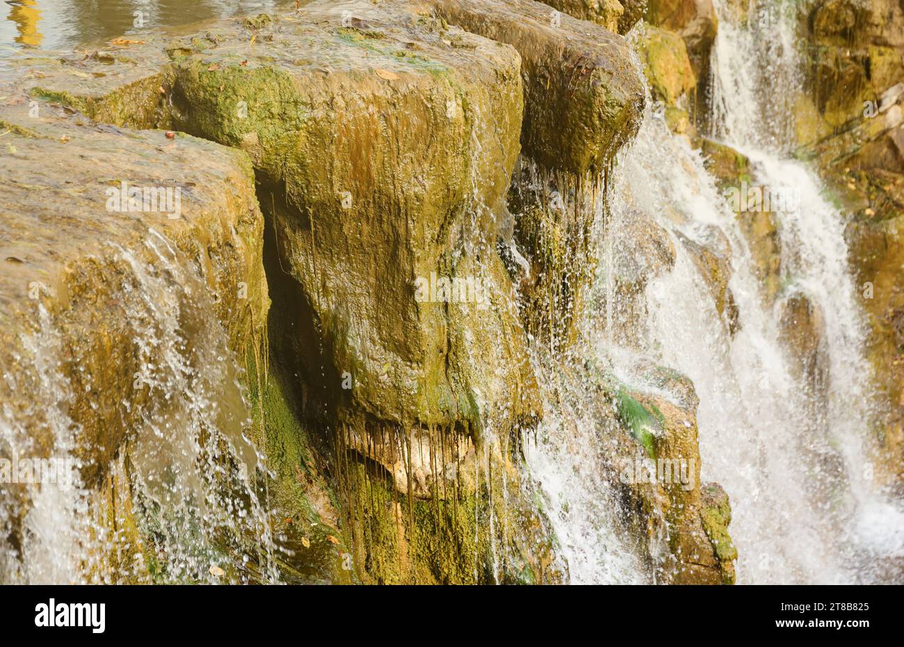 Beautiful waterfall between large rocks in the autumn forest ...