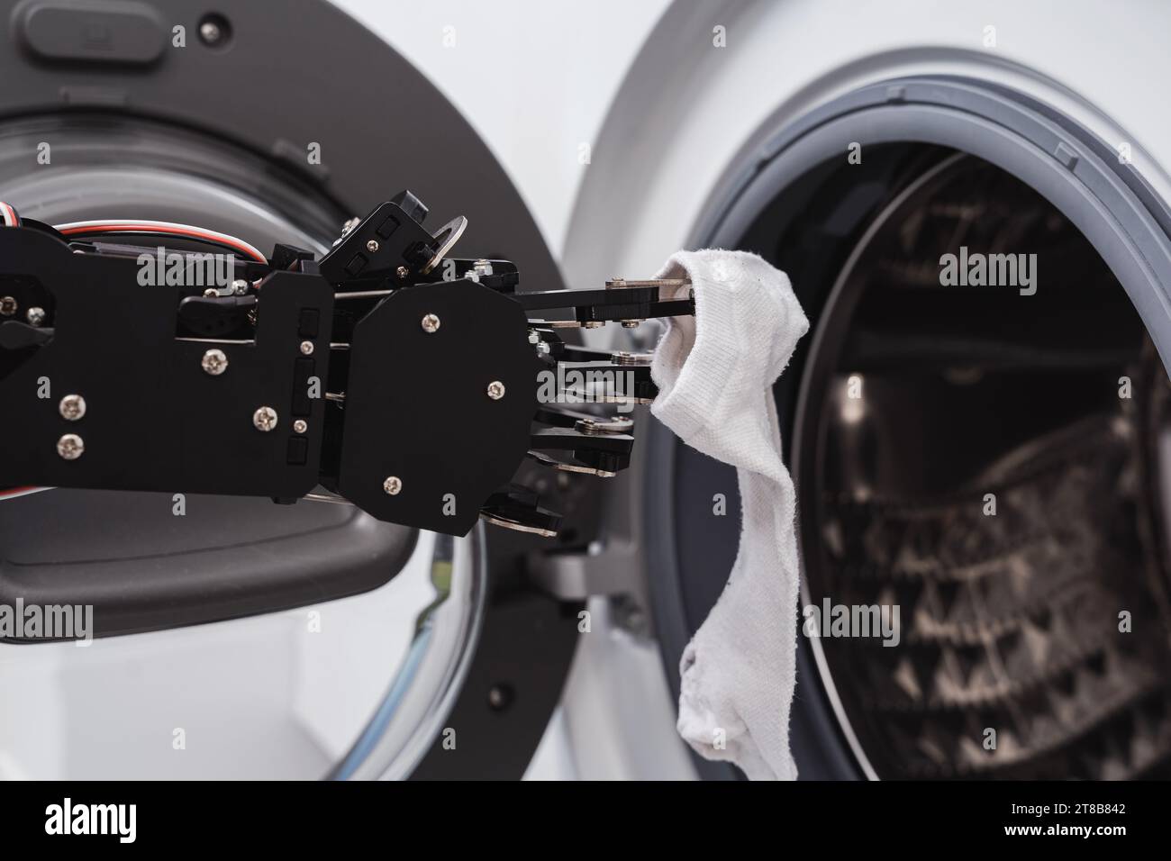 Real robot's hand and washing machine. Concept of Artificial ...