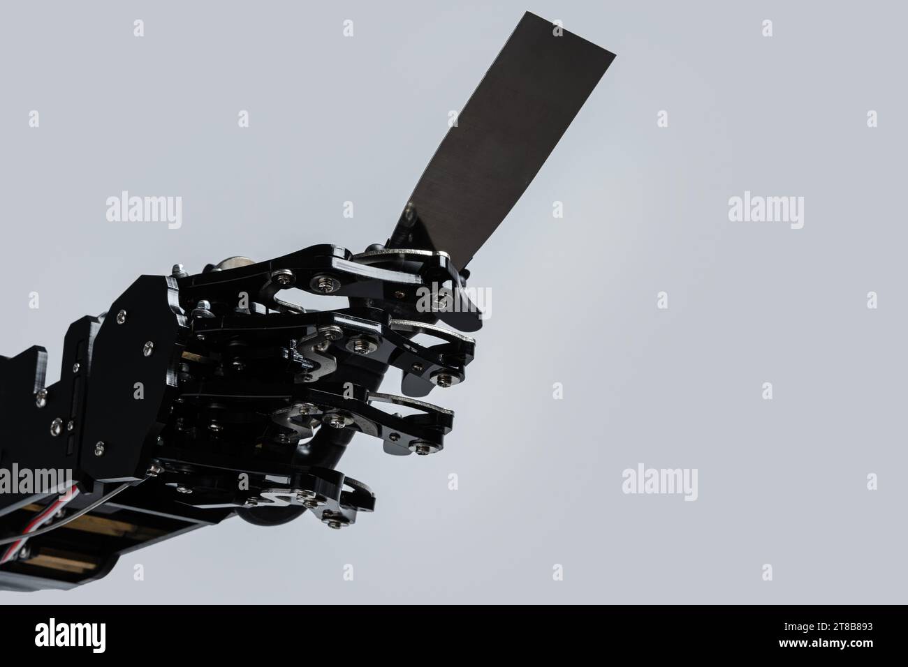 Real robotic hand with putty knife. Concepts of Artificial intelligence ...