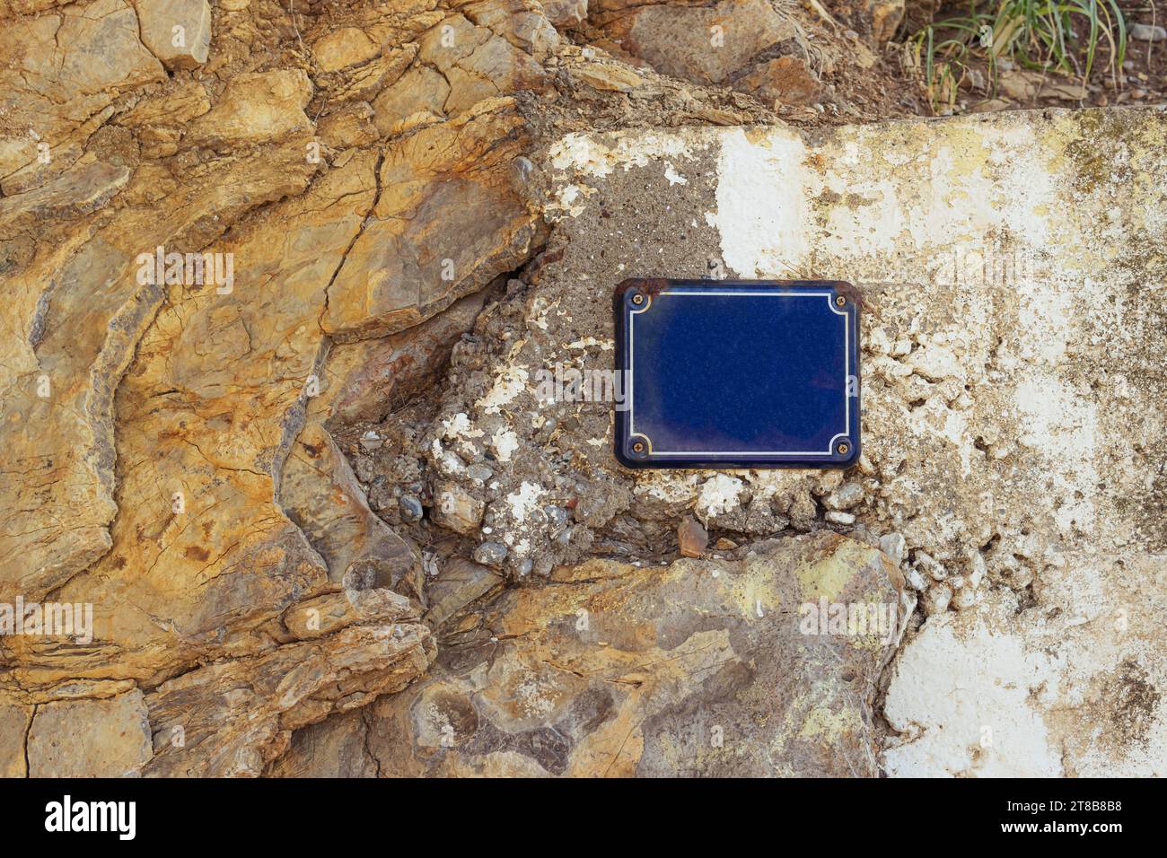 sign for the inscription on the street on the wall is attached in blue ...