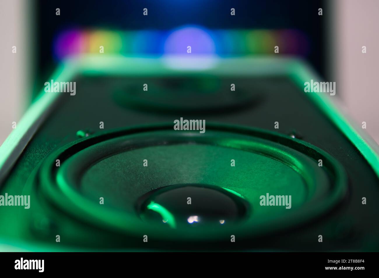 sound speaker in green neon light.Powerful music,blurred background ...