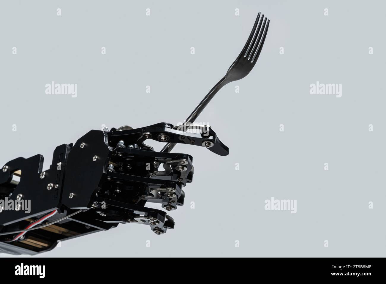 Real robot's hand with fork. Concept of AI development and robotic ...