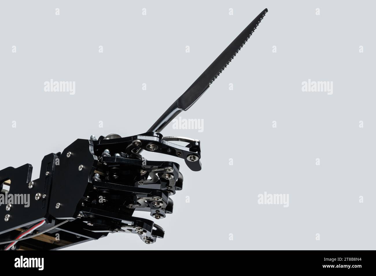 Real robot's hand with steak knife. Concept of AI development and ...