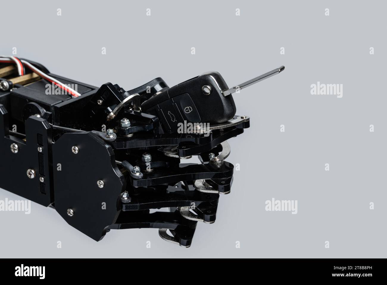Real robotic hand with black car key. Concept of Artificial ...