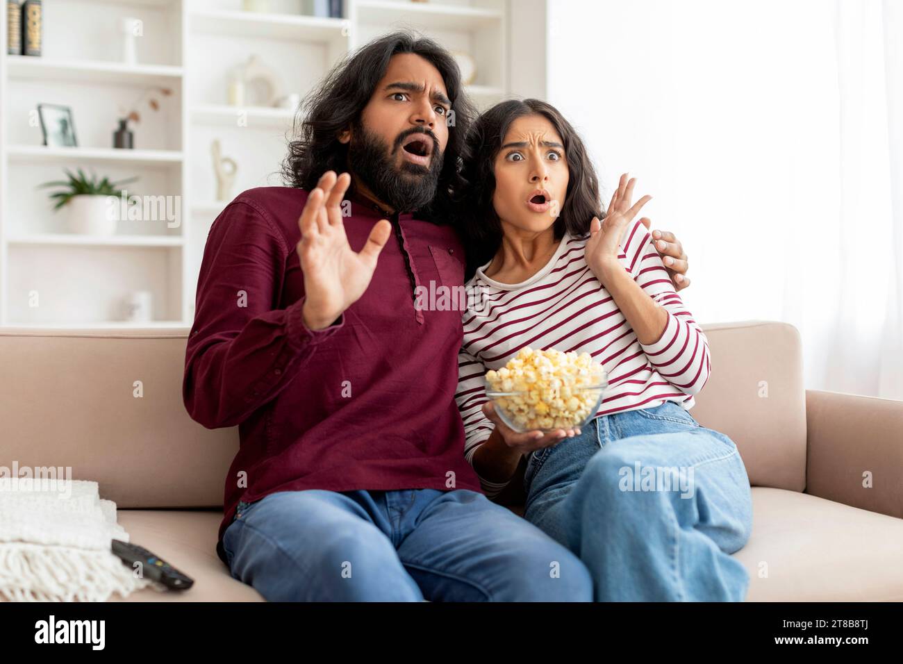 Scared young indian couple watching horror movie on TV Stock Photo - Alamy