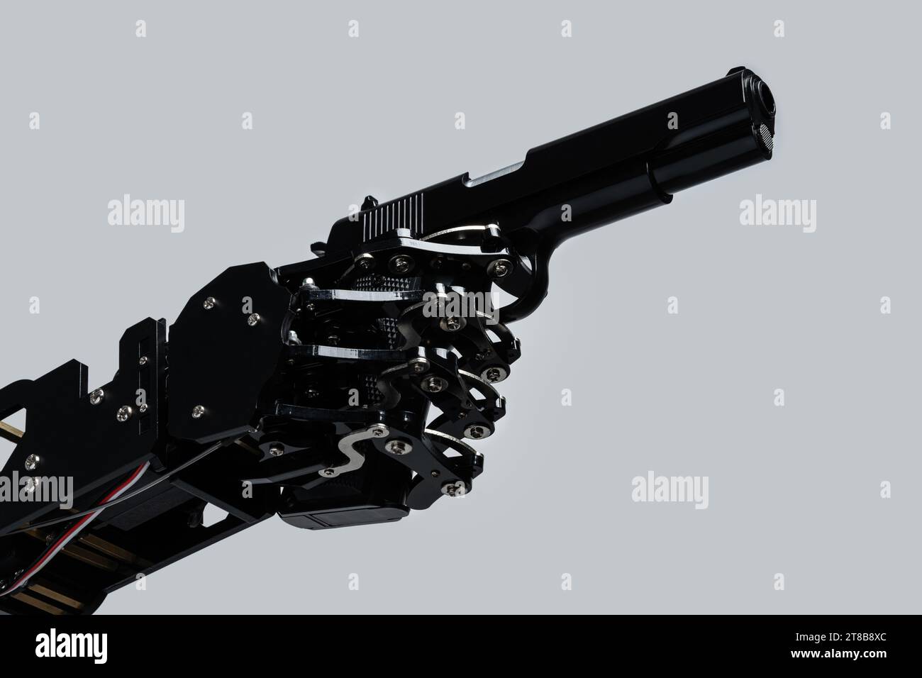 Real robot's hand with handgun. Concept of AI takeover and ...