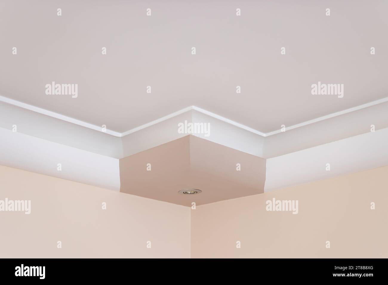 Ornamental white molding decor on the ceiling detail of a white room ...
