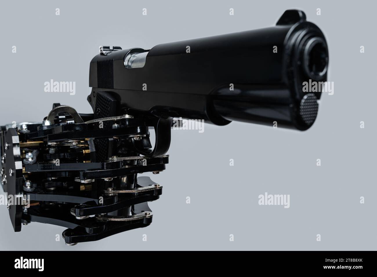 Real robot's hand with handgun. Concept of AI takeover and ...