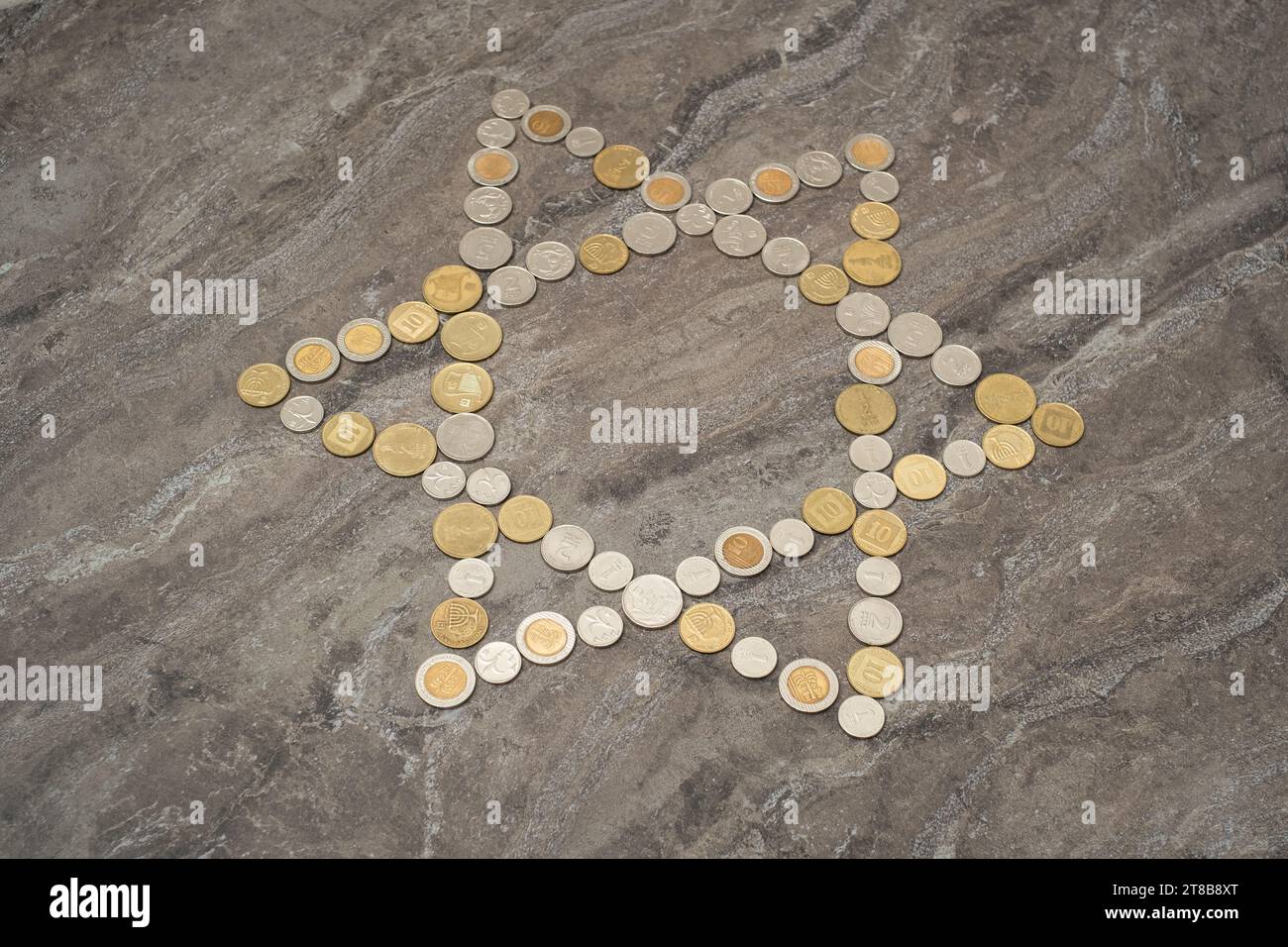 Israel's new shekel (NIS) coins arranged to form the shape of the Magen ...