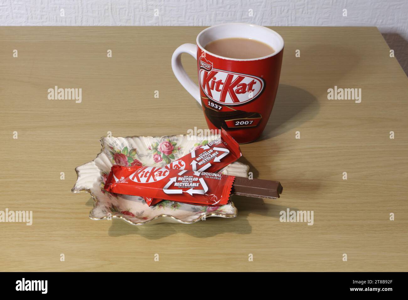 Kitkat mug with Kitkat bars of chocolate on table, snack food candy bar ...