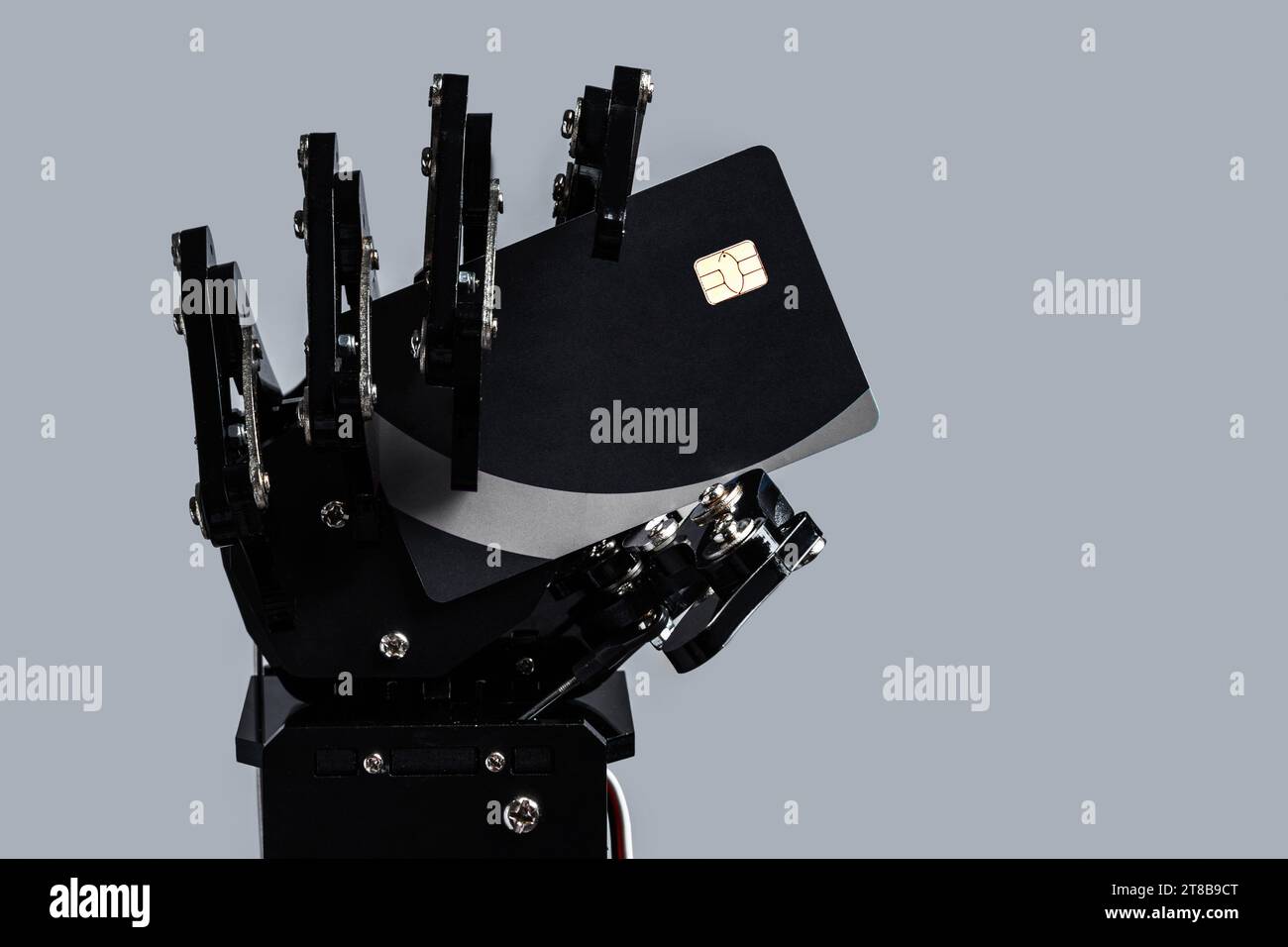Real robotic hand with black payment card. Concept of Artificial ...