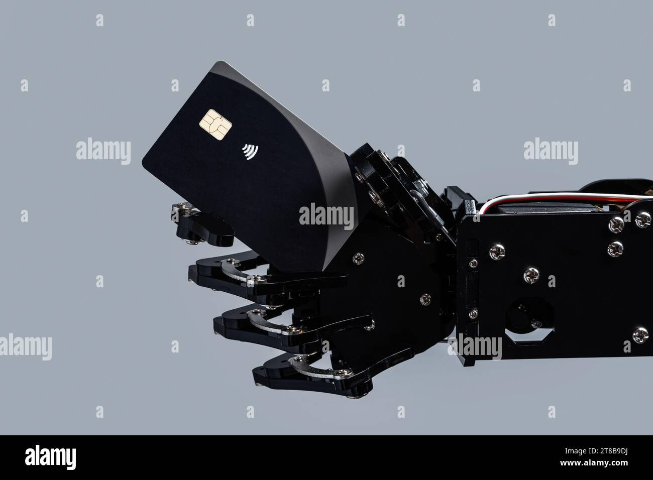 Real robotic hand with black contactless payment card. Concept of ...