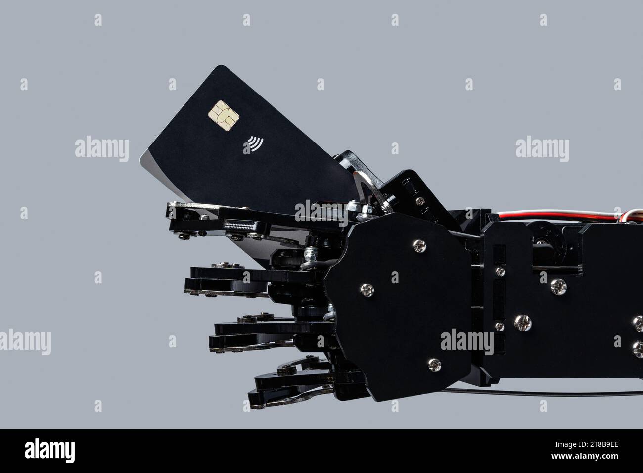 Real robotic hand with black contactless payment card. Concept of ...