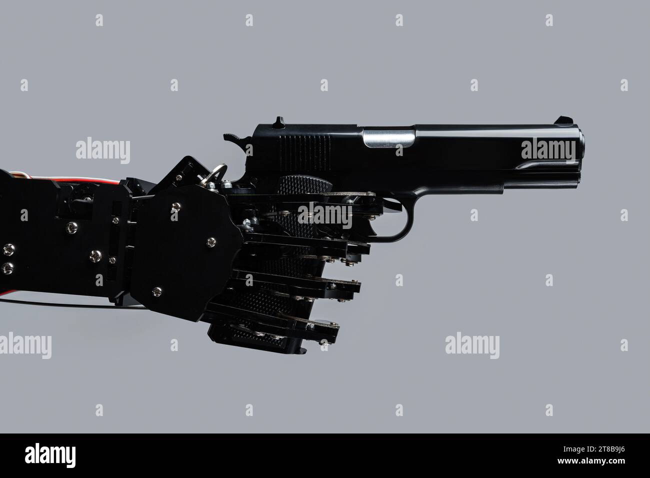 Real robot's hand with handgun. Concept of AI takeover and ...