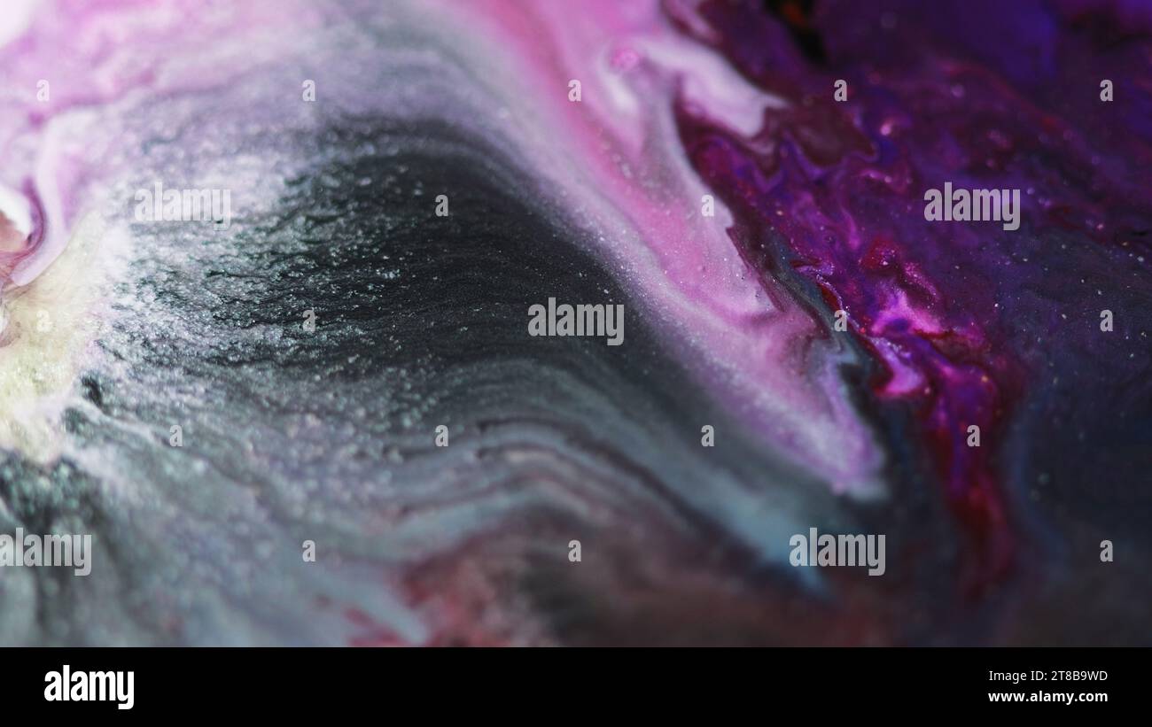 Glitter fluid wave paint water flow purple black Stock Photo - Alamy